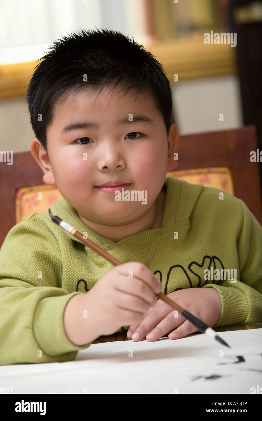 Young boy learning calligraphy Stock Photo - Alamy