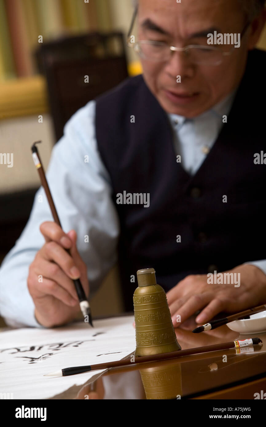 Middle-aged man practicing calligraphy Stock Photo - Alamy