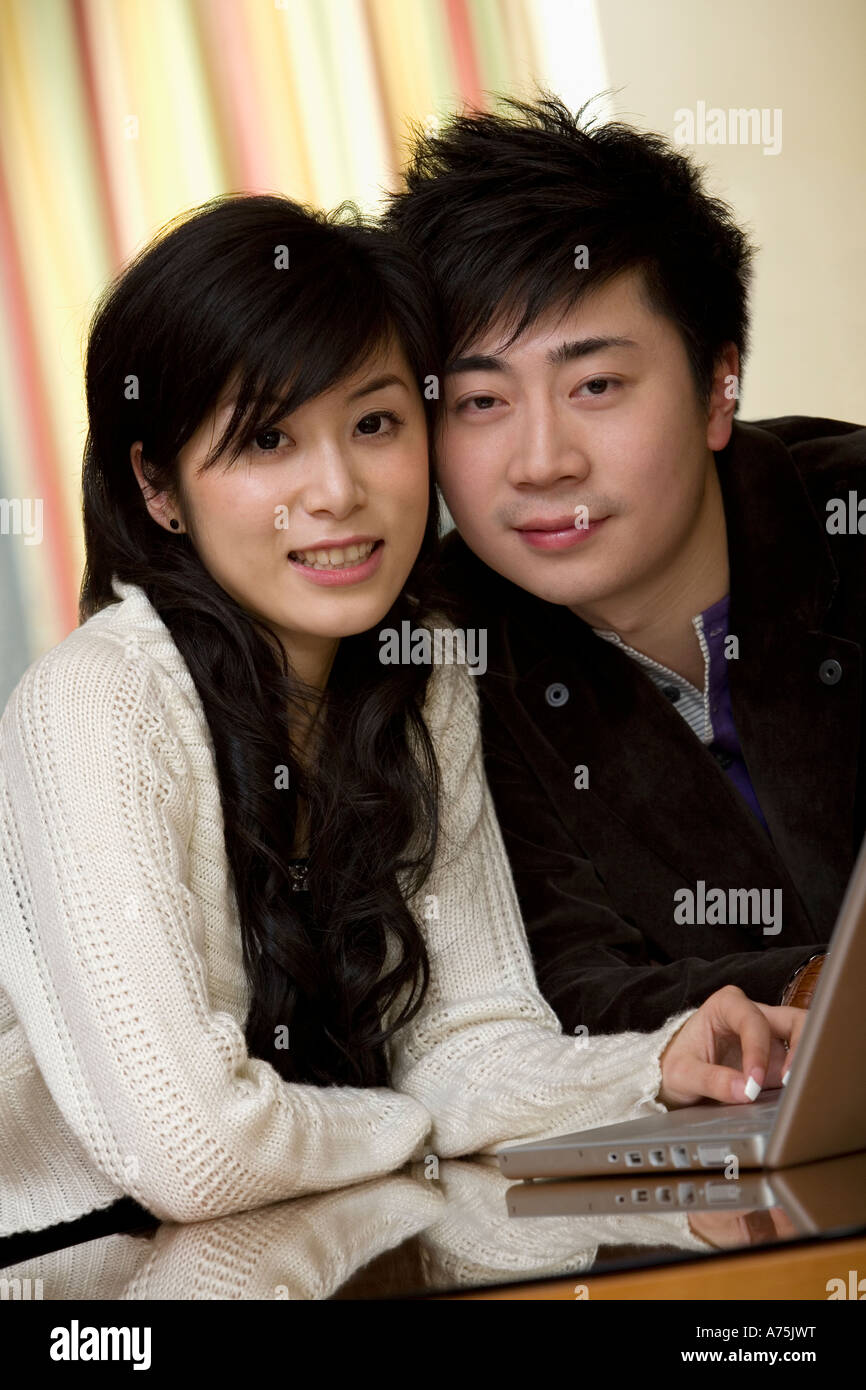 Couple using a laptop Stock Photo - Alamy
