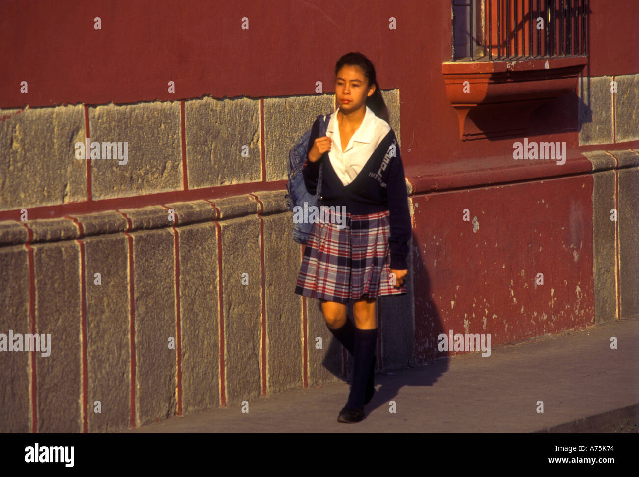 1 one Guatemalan girl female student wearing school uniform walking to ...