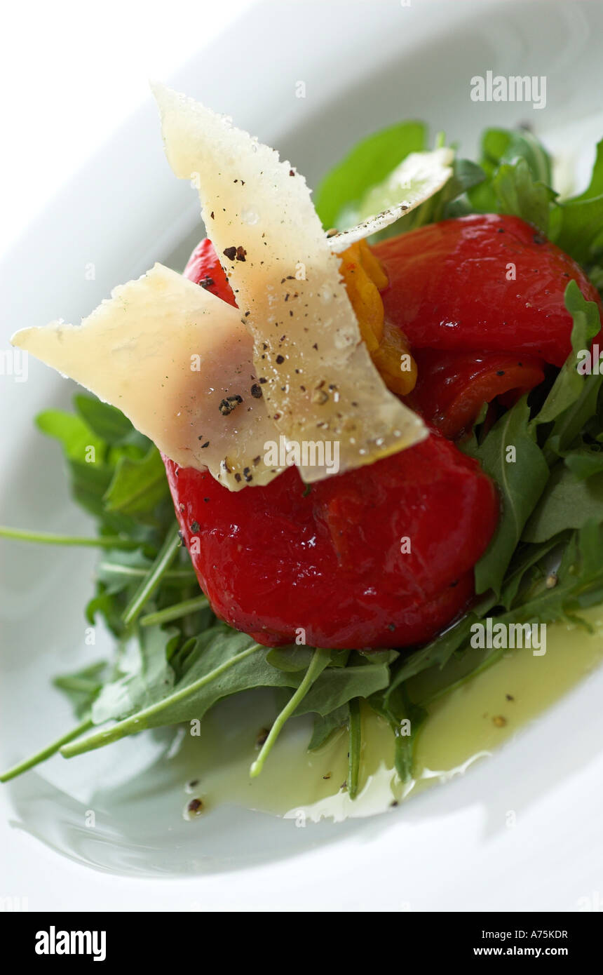 An antipasto selection of mixed roast peppers on a bed of rocket with ...