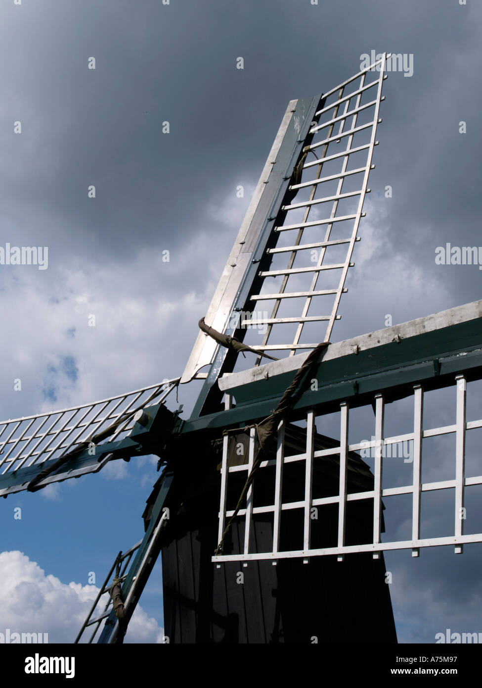 The curved wings of a historic small wooden windmill the symbol of ...