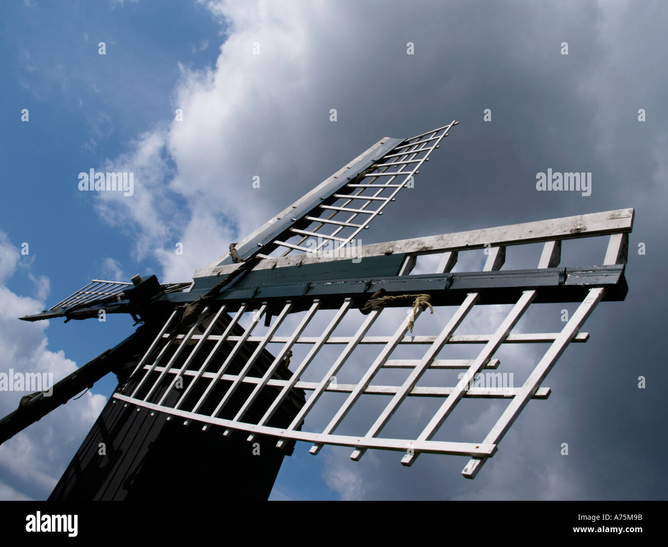 The curved wings of a historic small wooden windmill the symbol of ...
