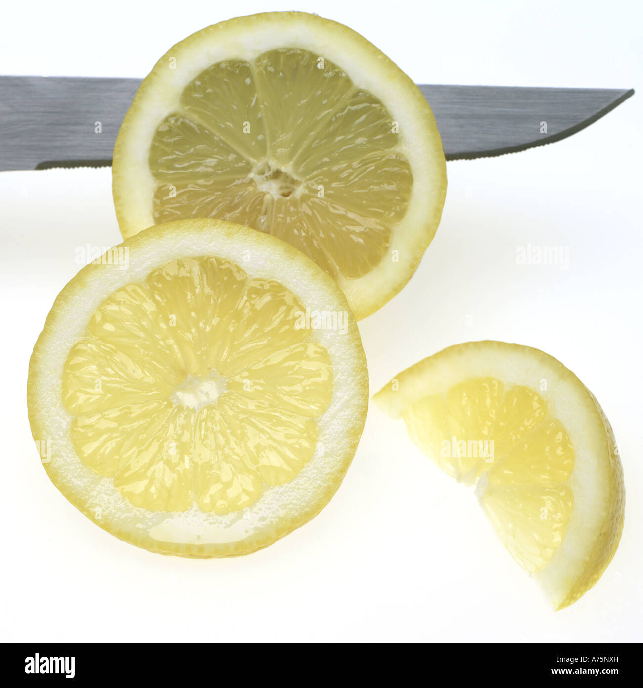 Lemon being cut into slices Stock Photo - Alamy