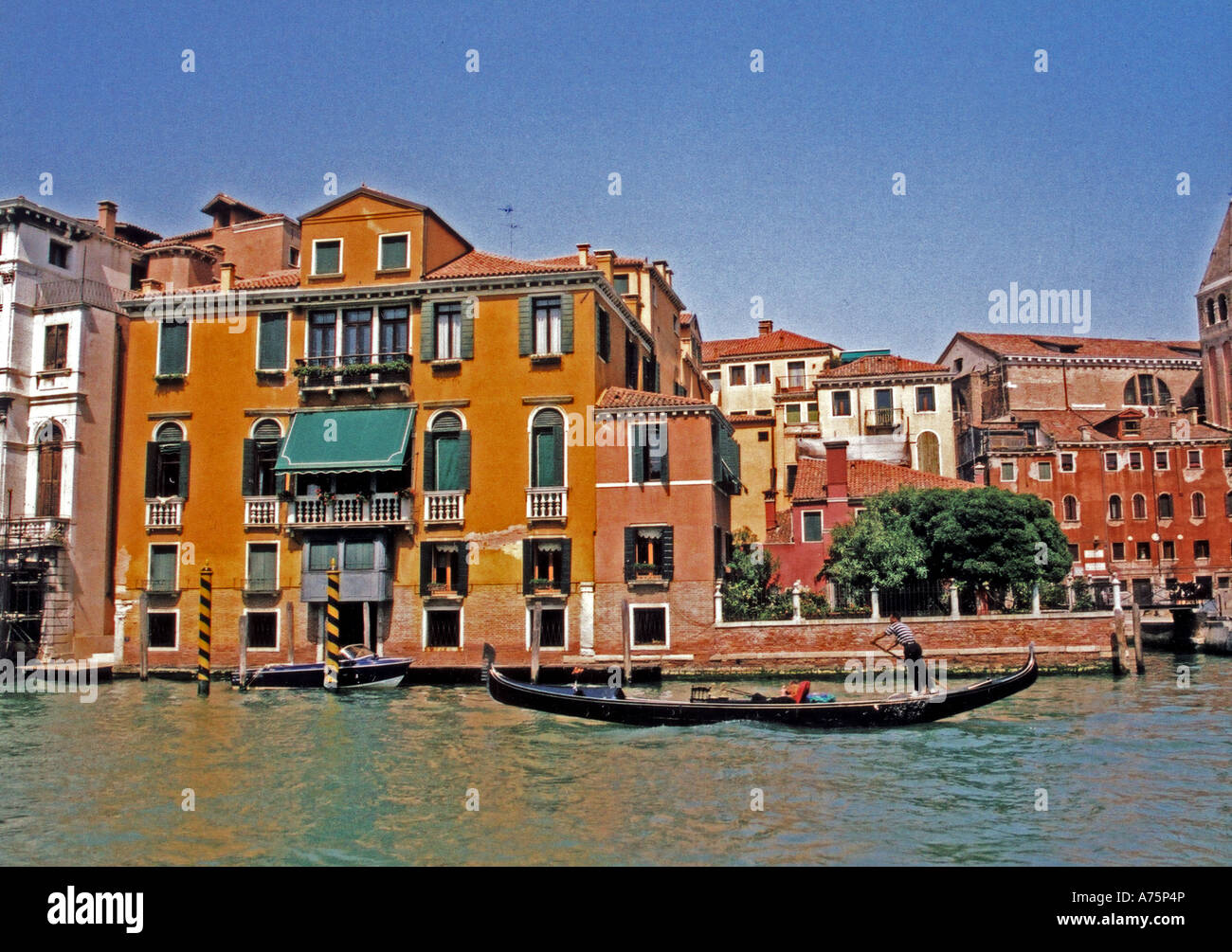 VENICE houses alongside the Grand Canal with a passing gondola Stock ...