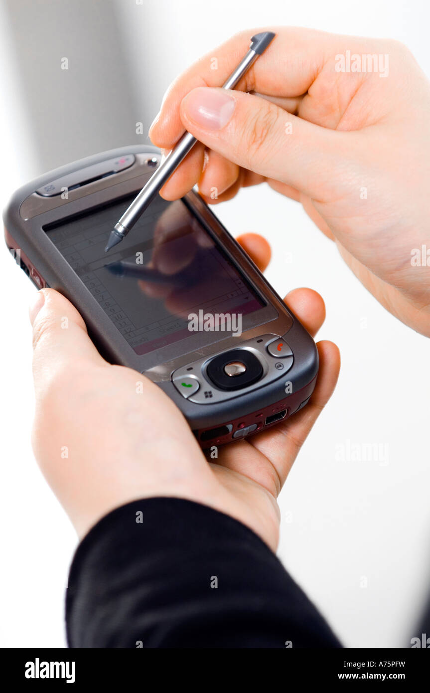 White womans hands holding and operating a modern mobile cell phone ...