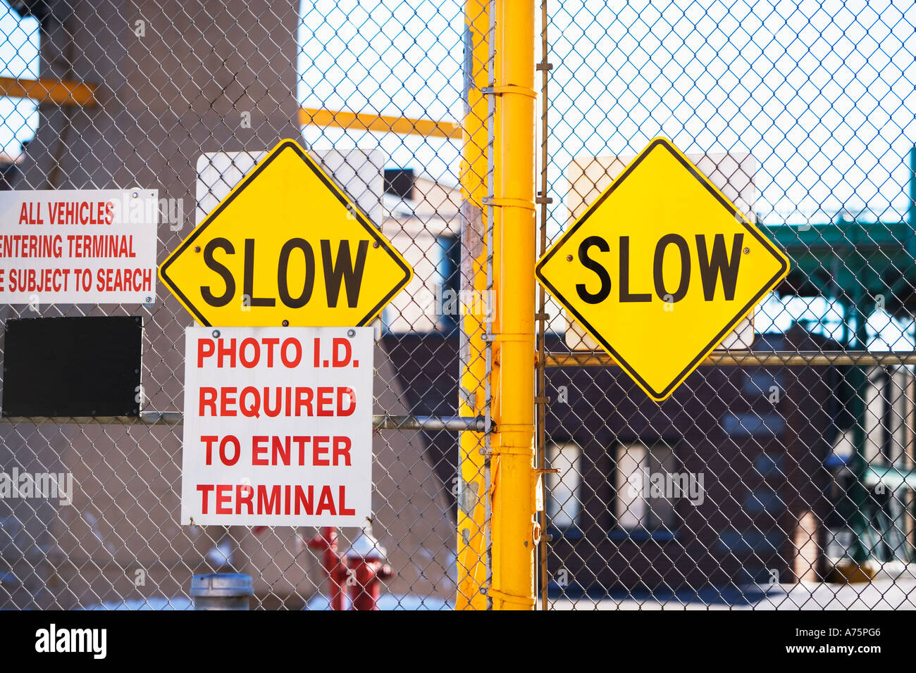 SLOW SIGNS ON FENCE Stock Photo - Alamy