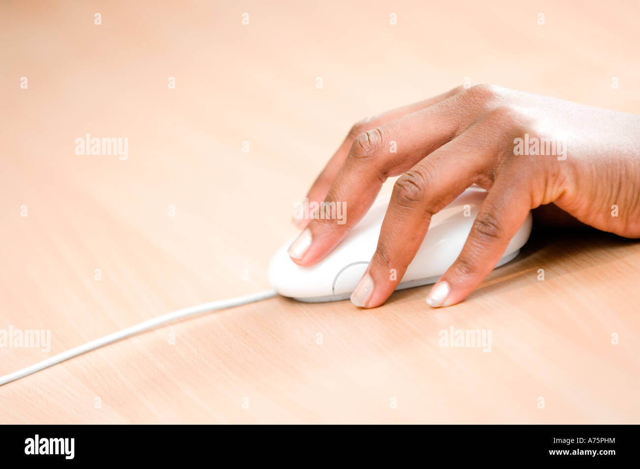 Close up picture of a black womans hands holding a computer mouse on a ...