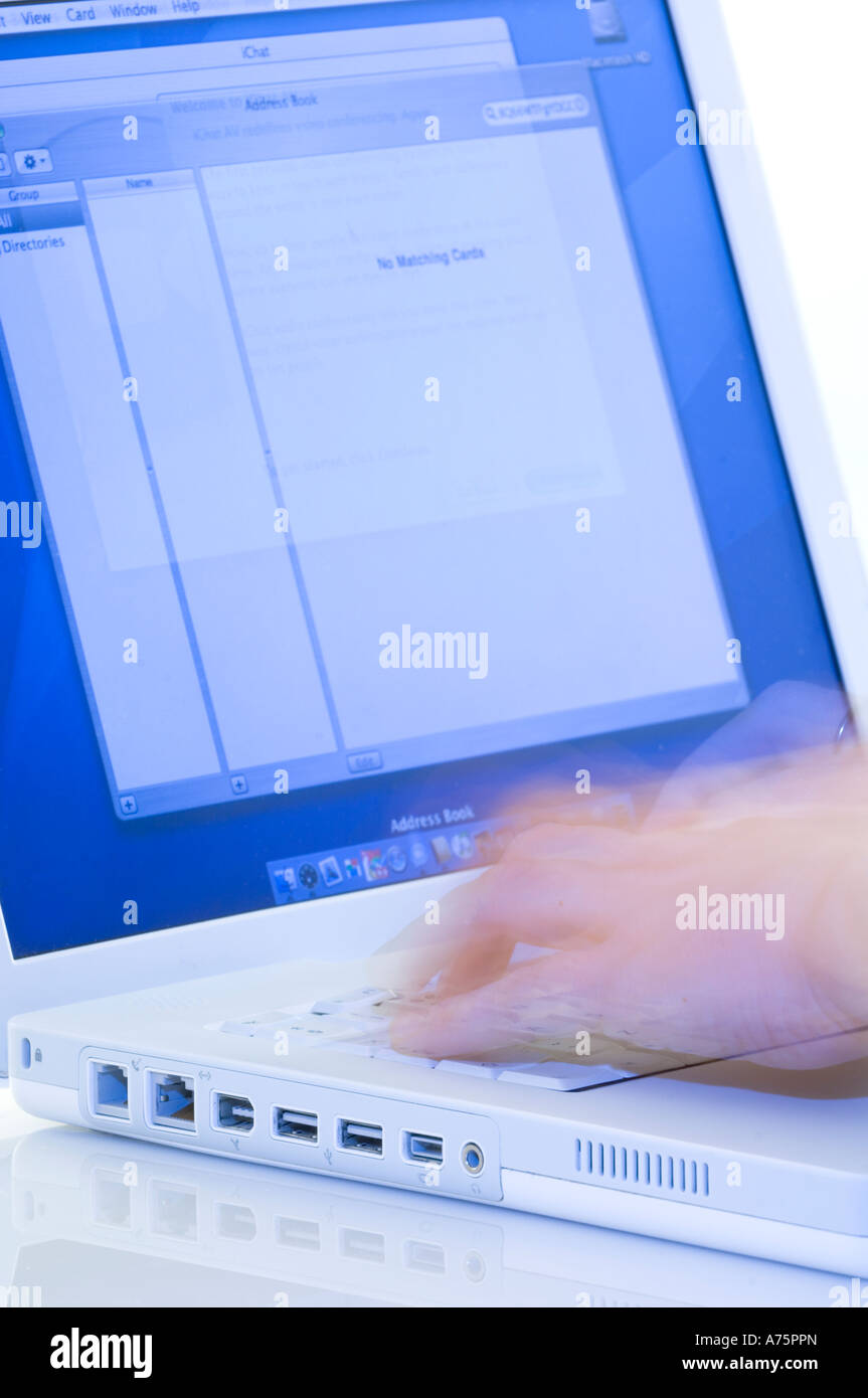Hands typing at speed on laptop computer keyboard against white ...