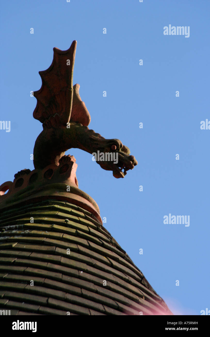 dragon gargoyle on top of a round gate house in malvern, worcestershire ...