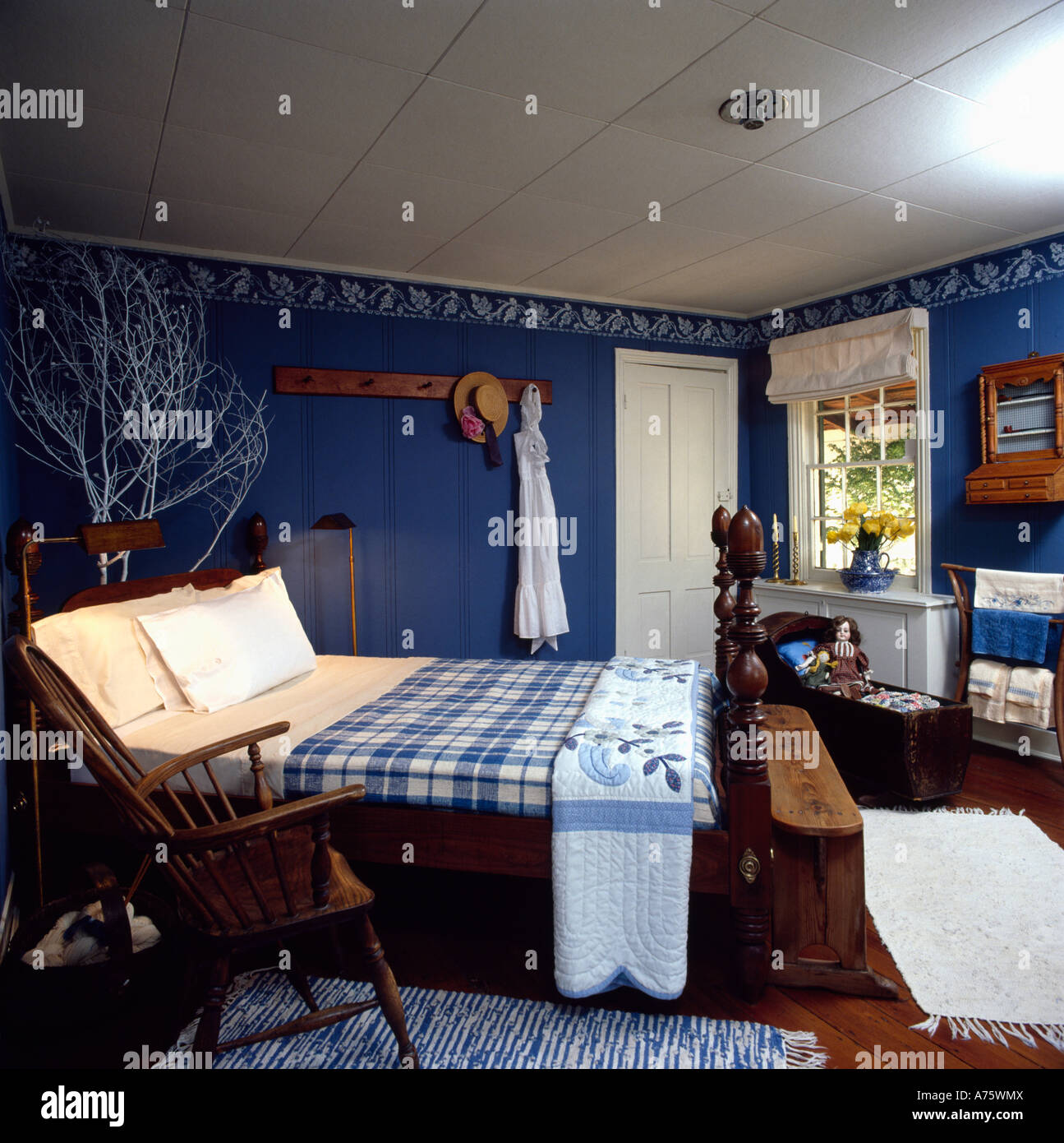 Blue country bedroom with blue & white check blanket on bed and antique ...