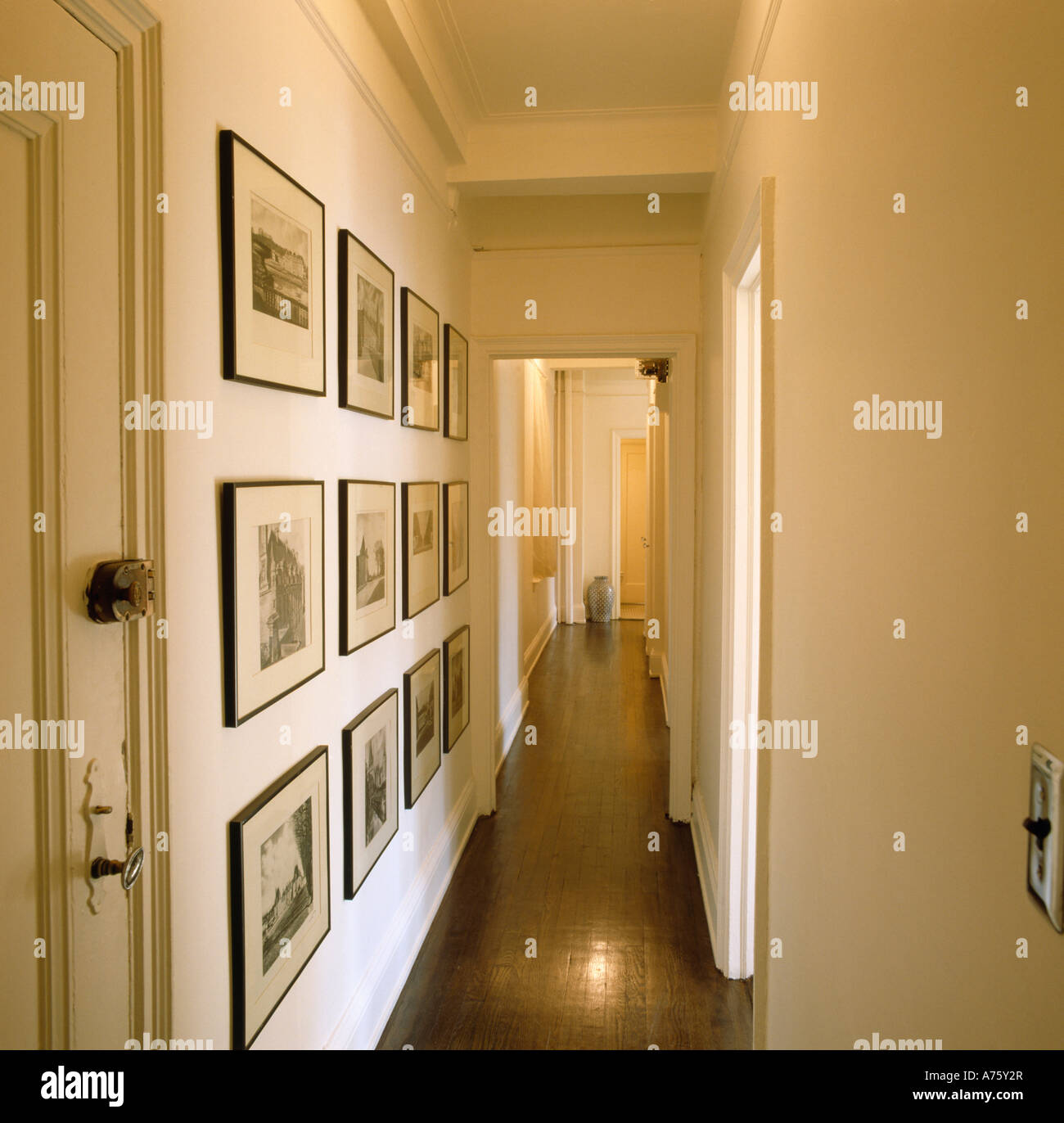 Polished wooden floor in neutral corridor with rows of pictures Stock ...
