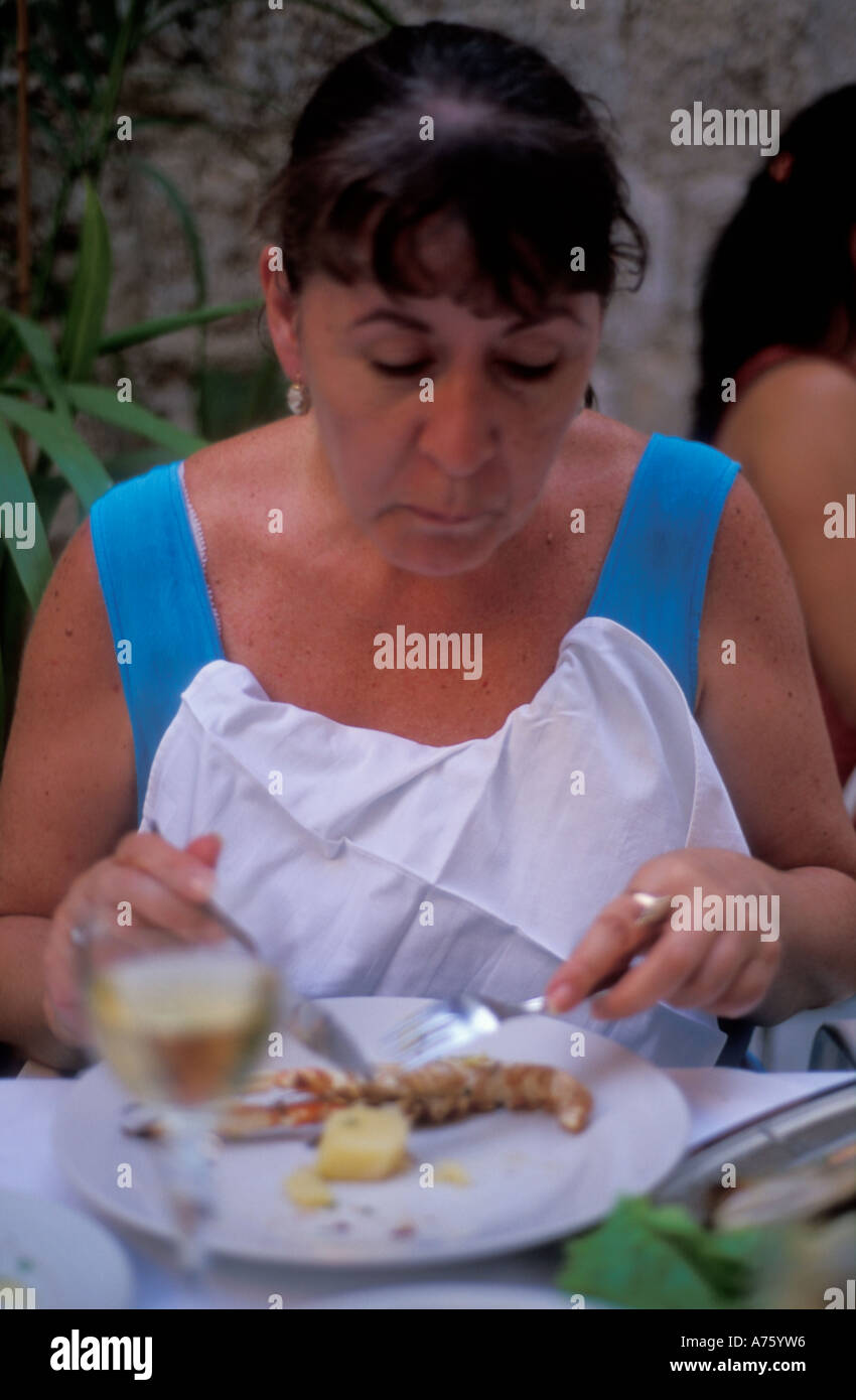 Woman eating fish in a restaurant in Trogir in Croatia Stock Photo - Alamy