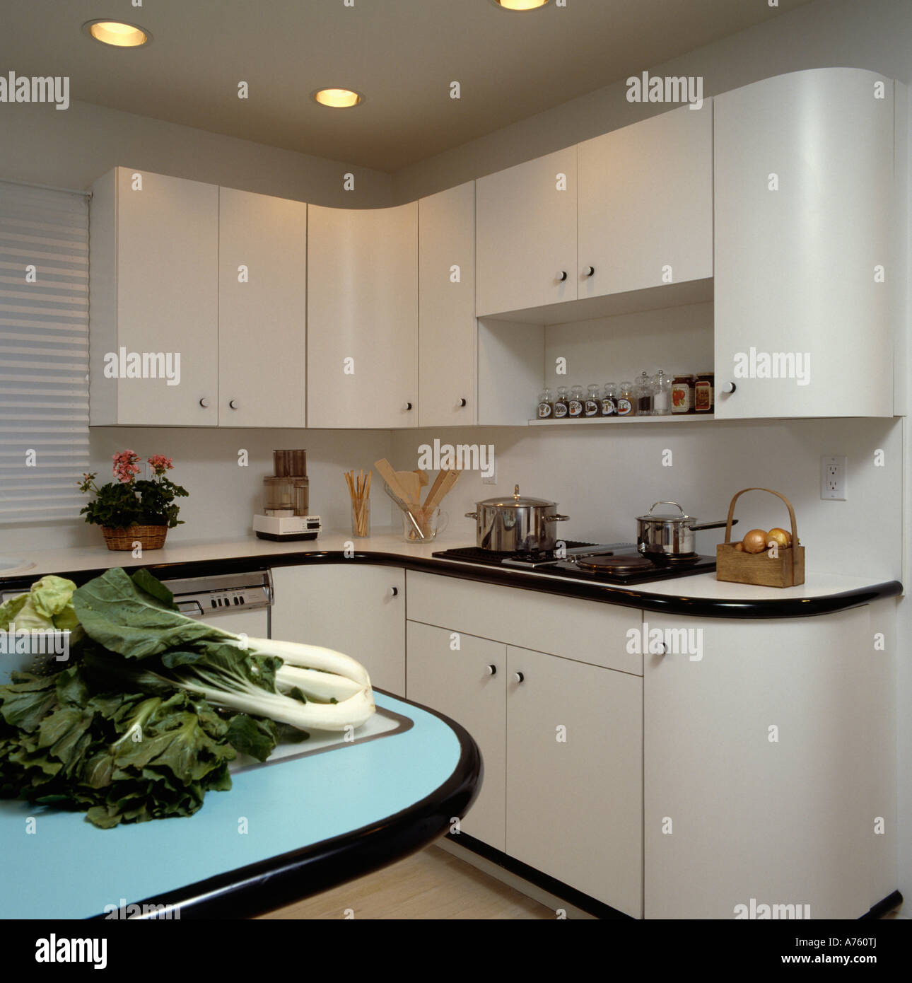 Pak choi on blue worktop in small modern white kitchen Stock Photo - Alamy