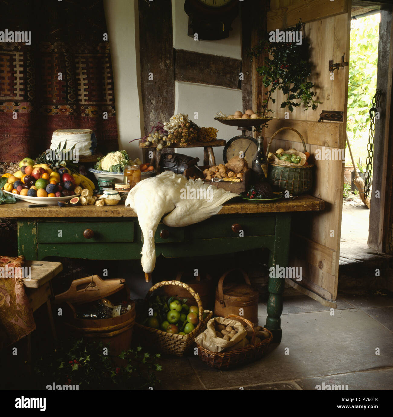 Table in country kitchen with poultry and vegetables ready for food ...