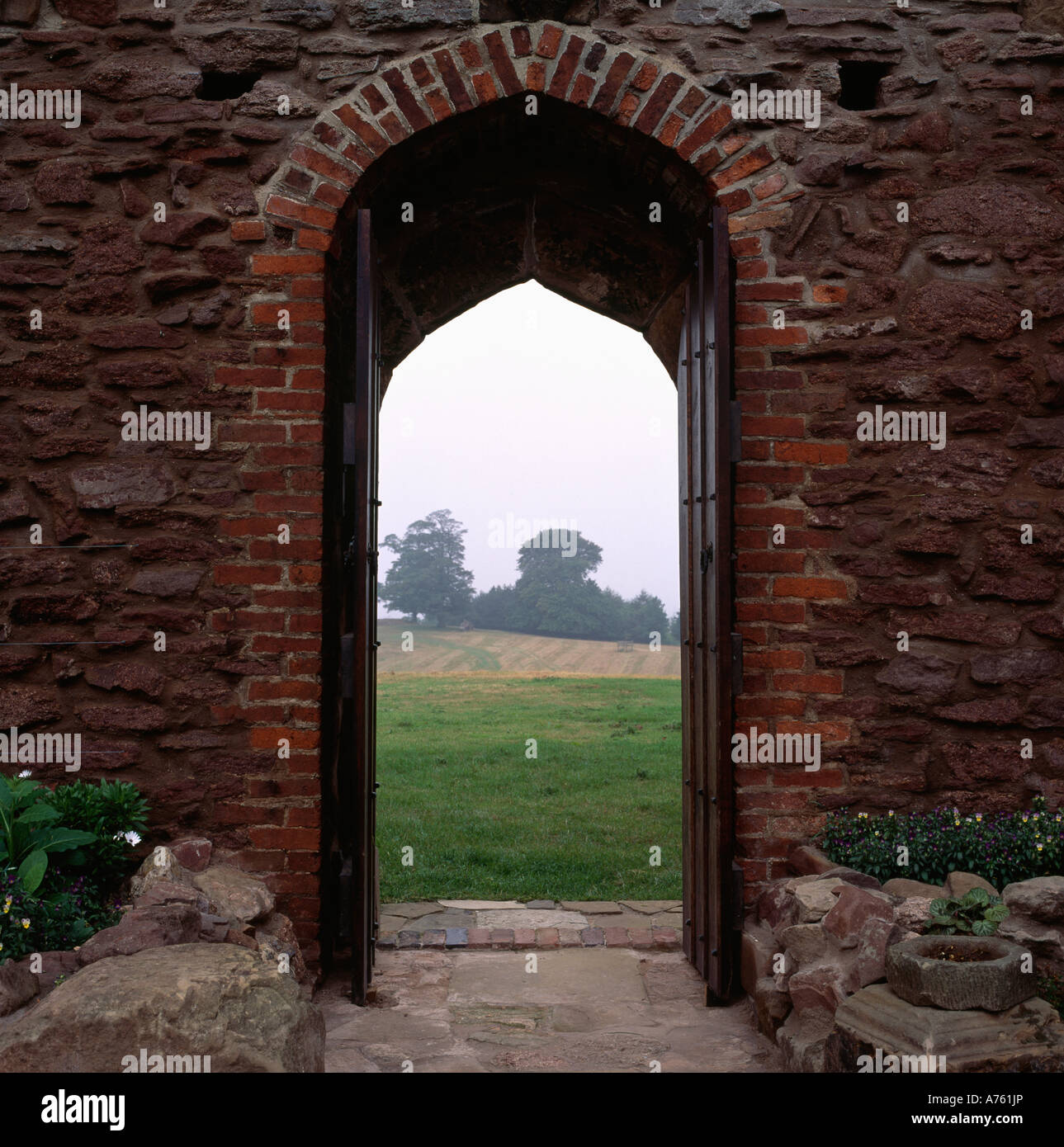 View of English countryside through open gateway in stone wall Stock ...