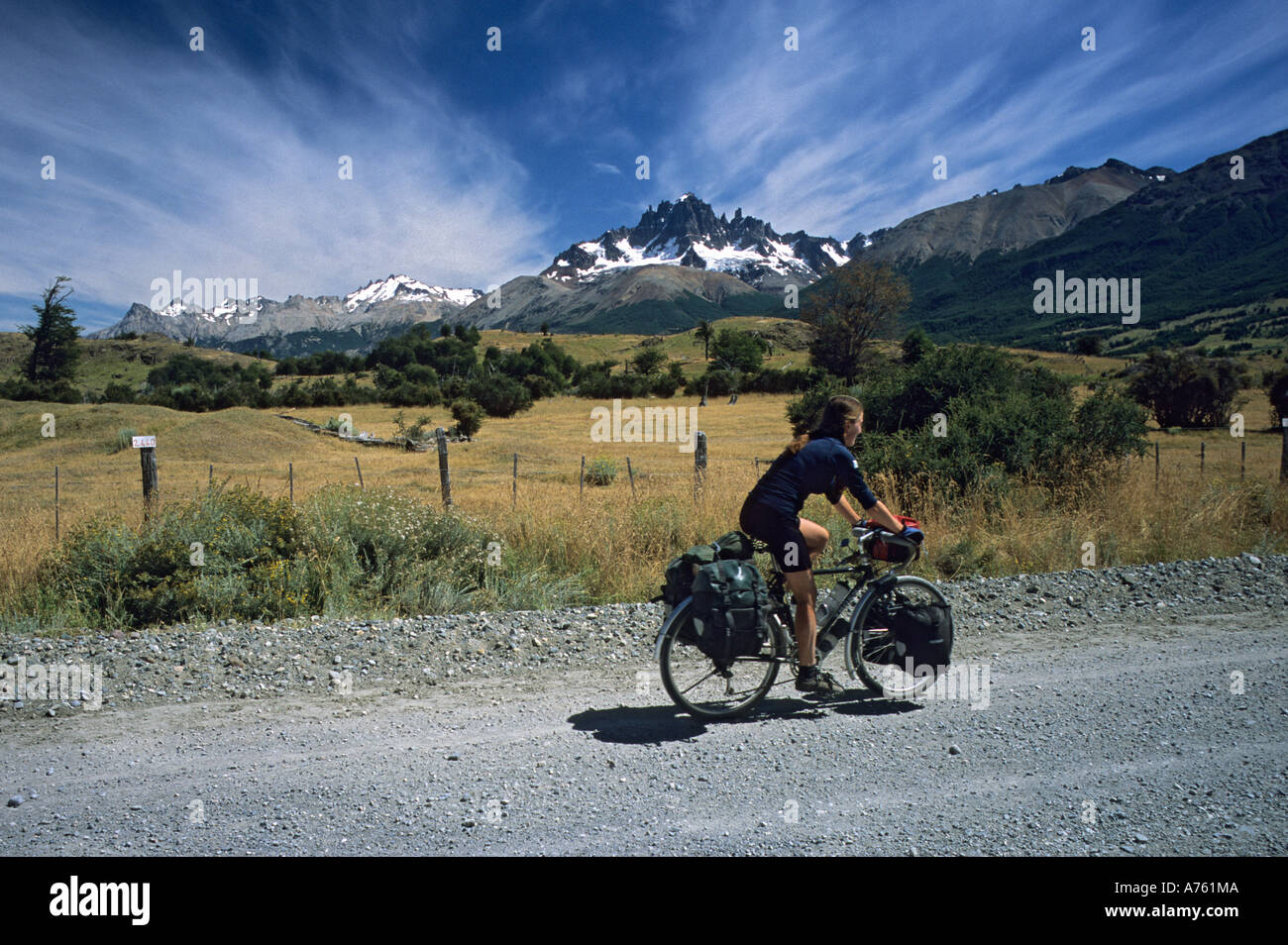 Female expedition touring cyclist alone on road in Chile with Cerro ...