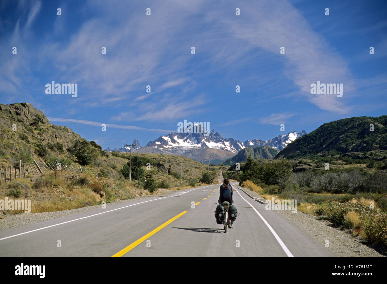Female expedition touring cyclist alone on road in Chile with Cerro ...