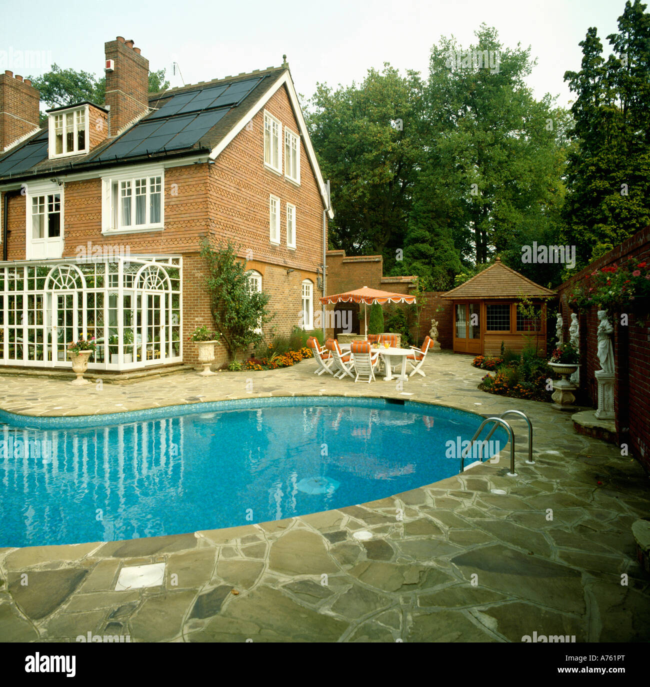 Traditional red brick country house with conservatory extension and ...