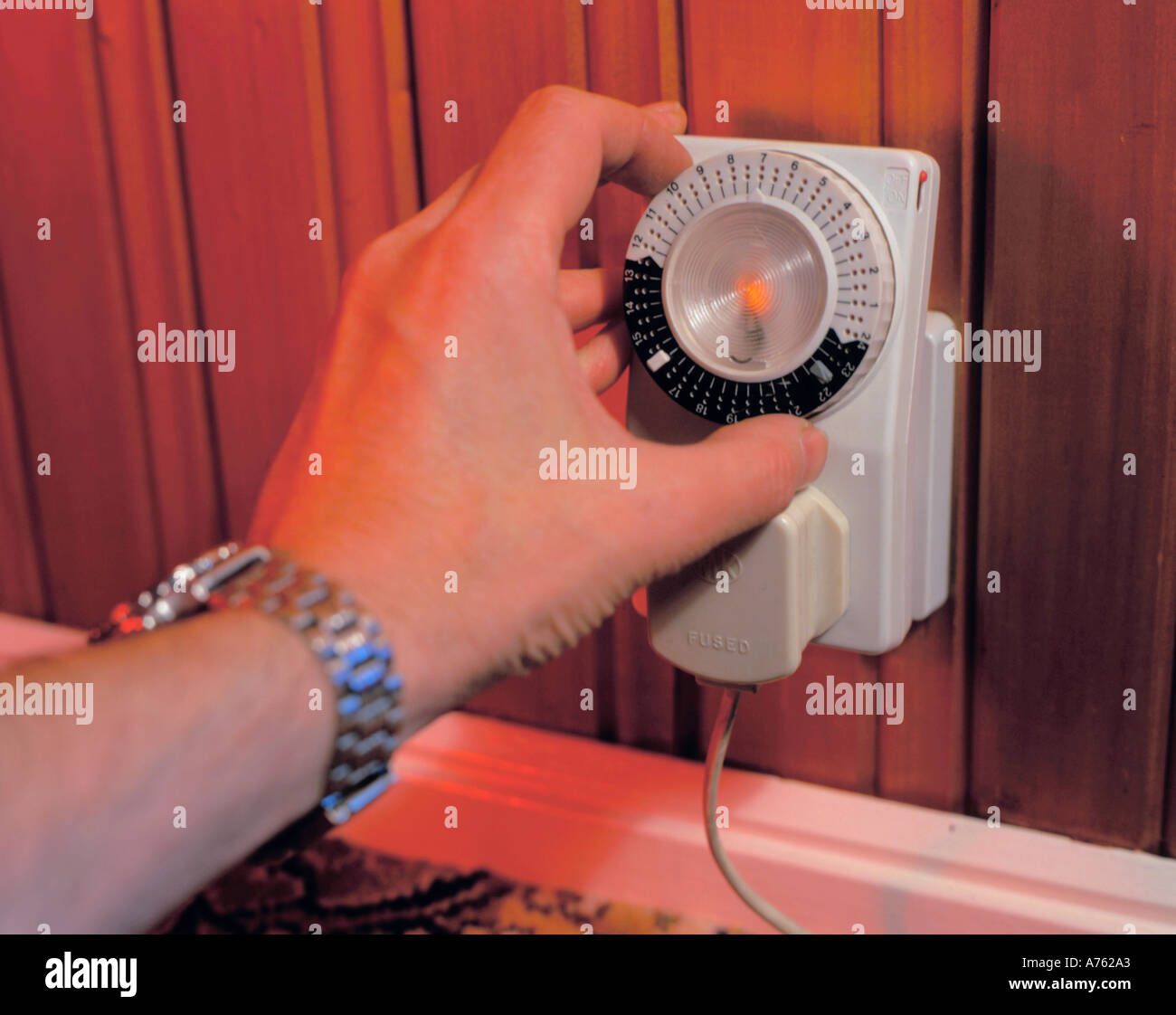 Domestic timer switch being set to operate a remote lamp, UK Stock ...