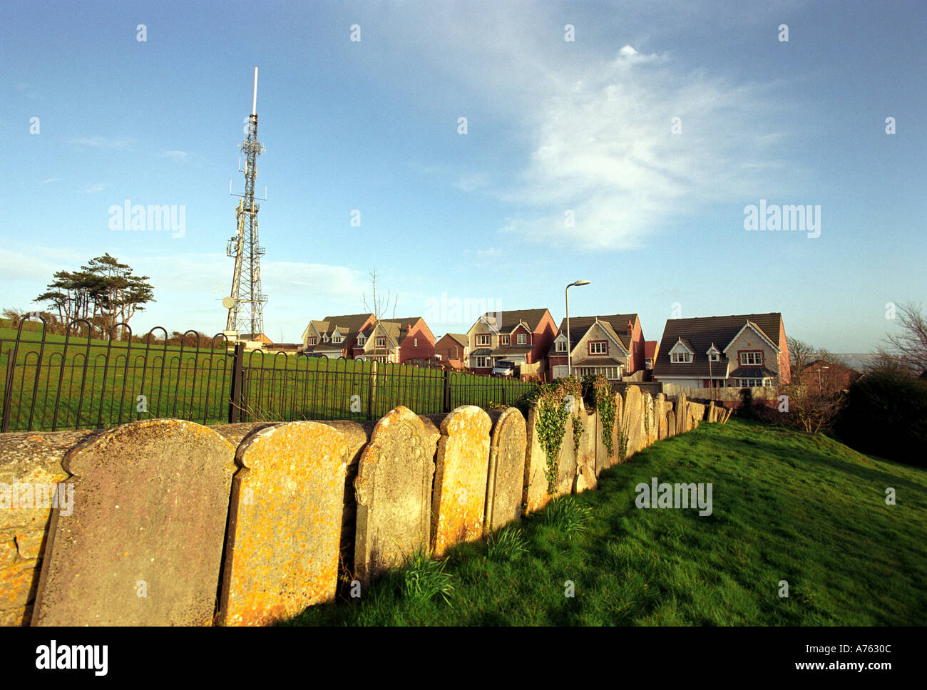 Communication Mast next to houses and grave yard Stock Photo - Alamy