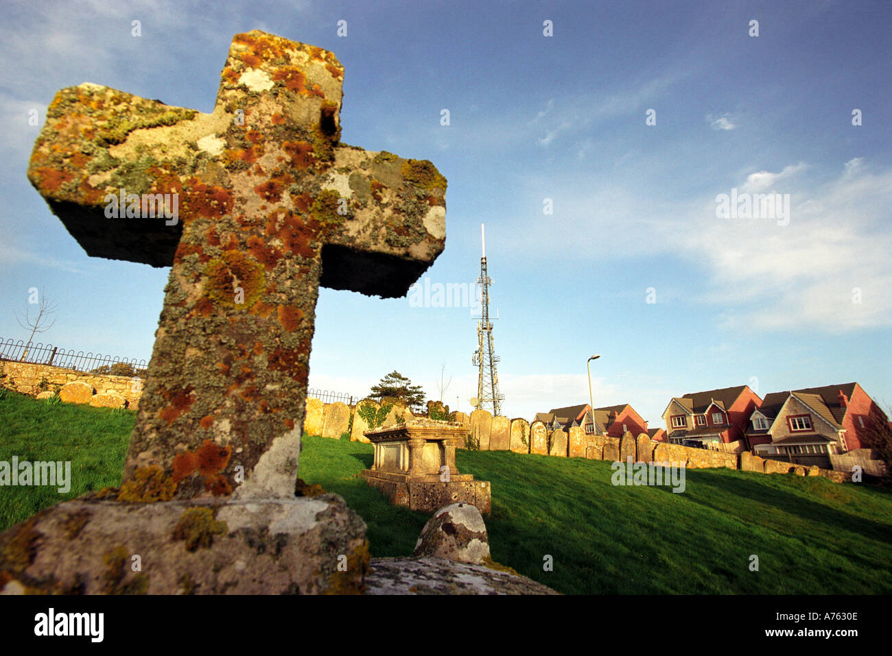 Communication Mast next to houses and grave yard Stock Photo - Alamy