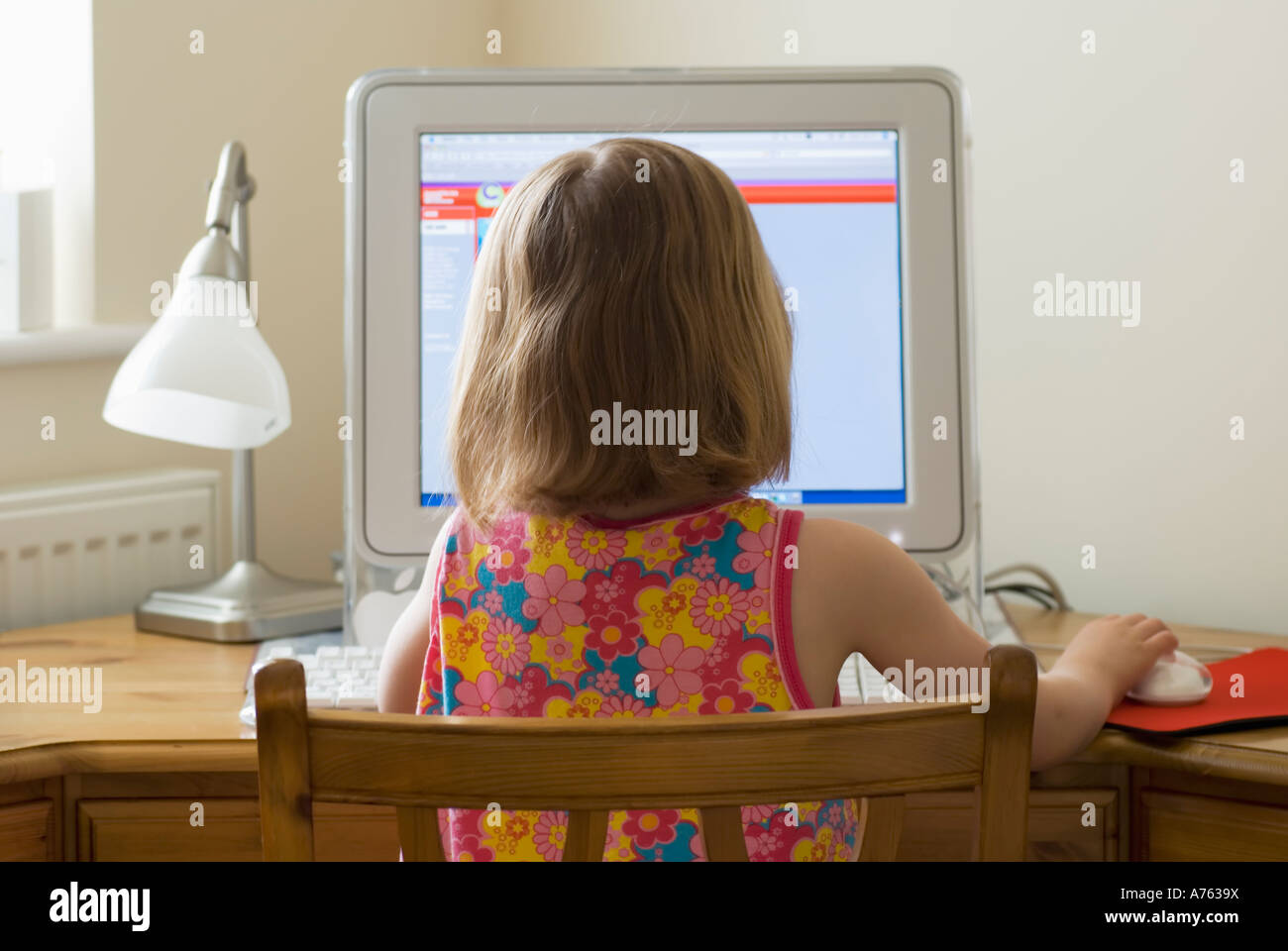 A young girl operating a computer Stock Photo - Alamy
