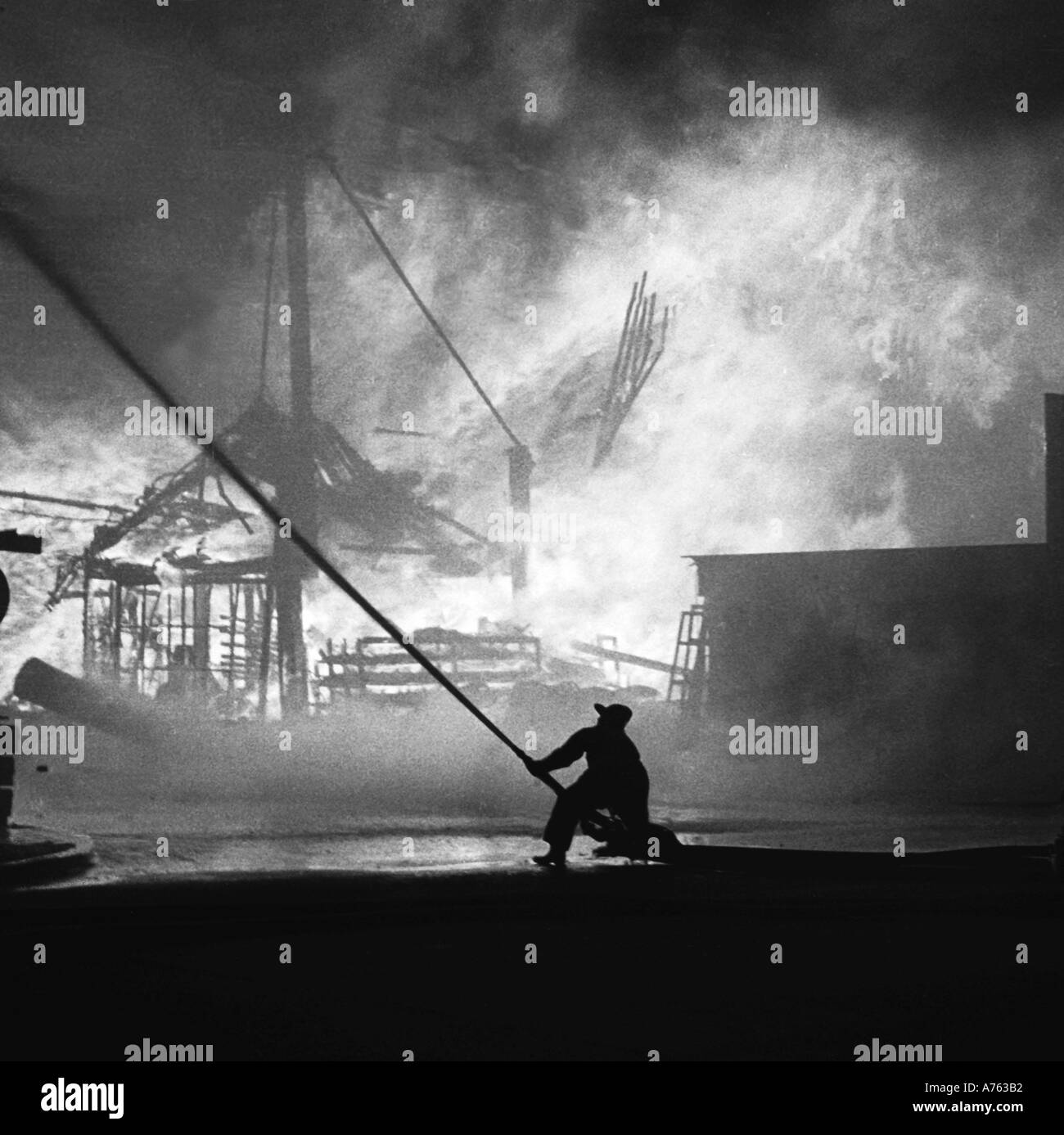 Fireman fighting fire Stock Photo - Alamy