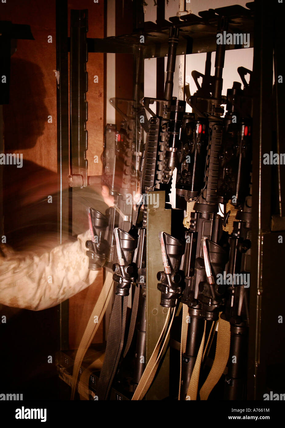 A Marine with the Incident Response Platoon pulls an M-4 rifle off of ...