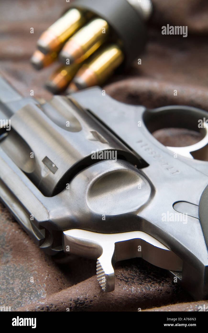 Gun macro with feed magazine in the background Stock Photo - Alamy