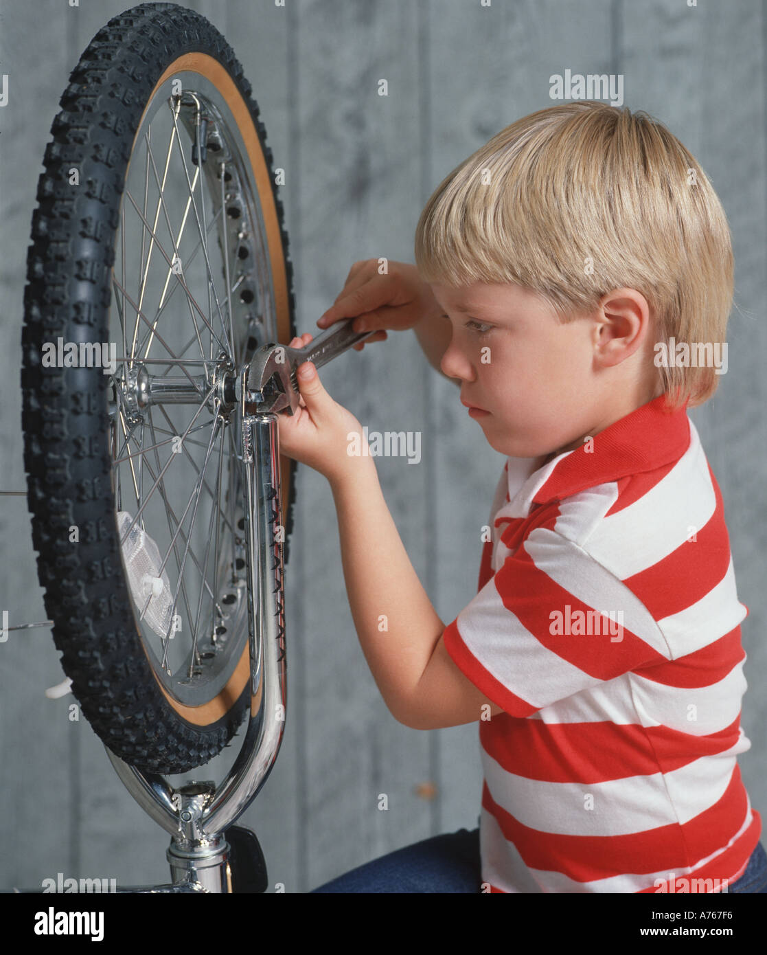 boy working on bicycle Stock Photo - Alamy