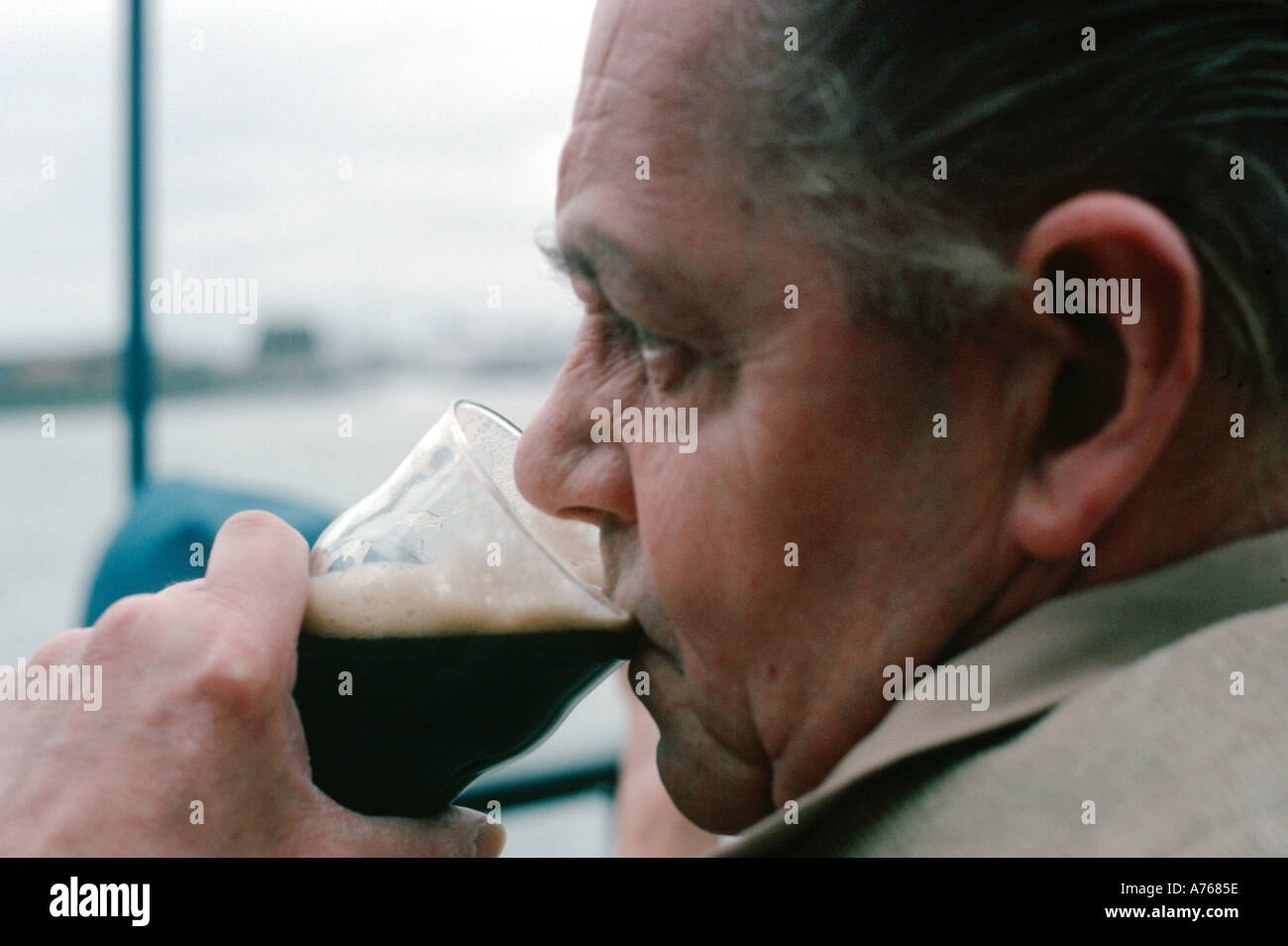 Man drinking a glass of Guinness Stock Photo - Alamy