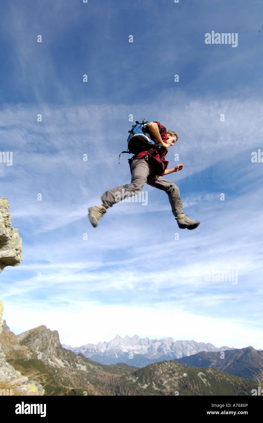 Man jumping in mountains Stock Photo - Alamy