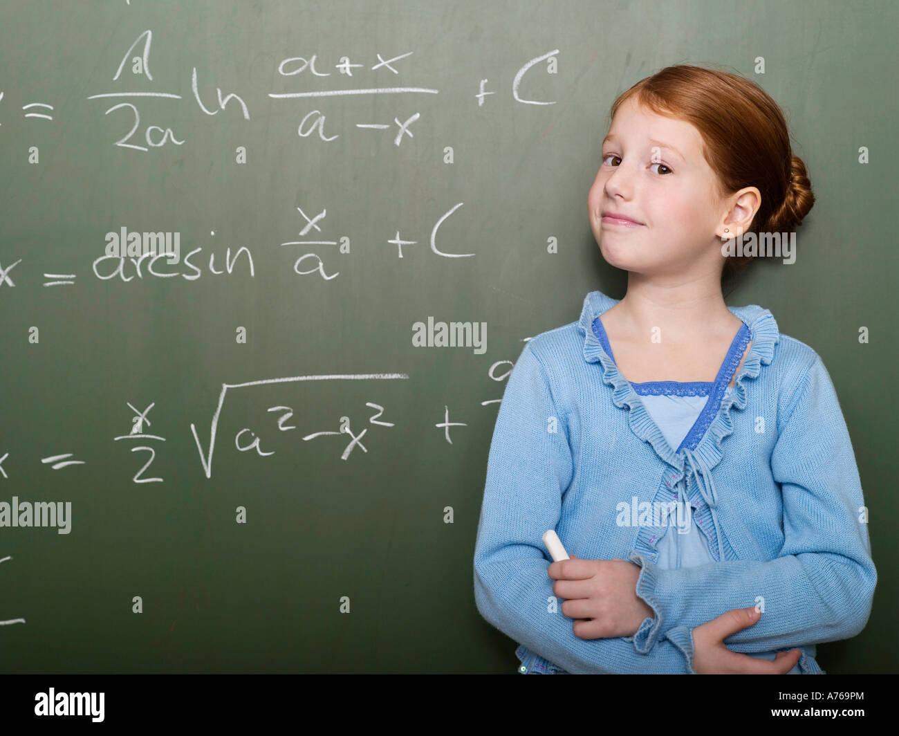 Girl (4-7) standing by blackboard, portrait, close-up Stock Photo - Alamy