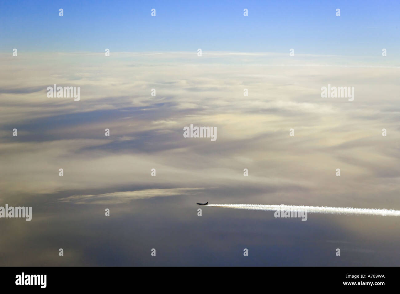 A passenger jet viewed from above in another aircraft flying through ...