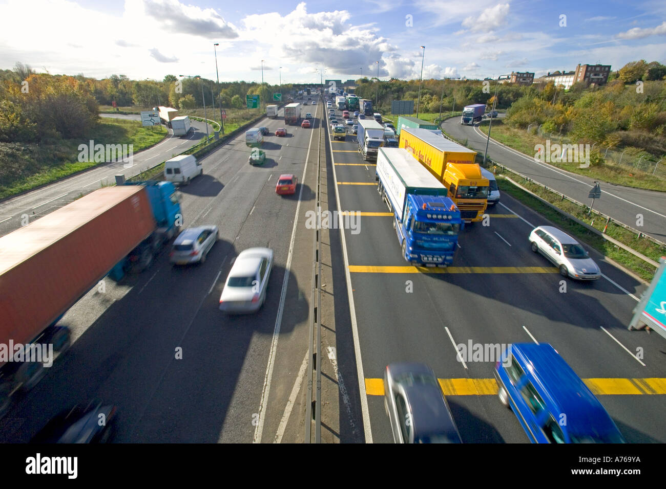 A wide angle view of traffic approaching the tolls of the QE2 bridge ...