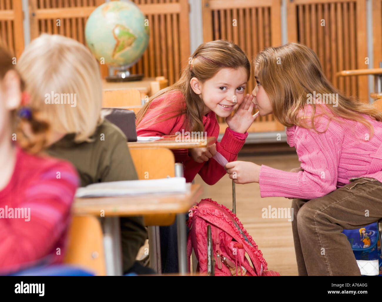 Girls talking in class Stock Photo - Alamy
