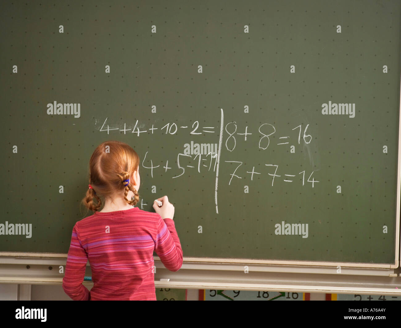 Pupil writing numbers on blackboard hi-res stock photography and images ...