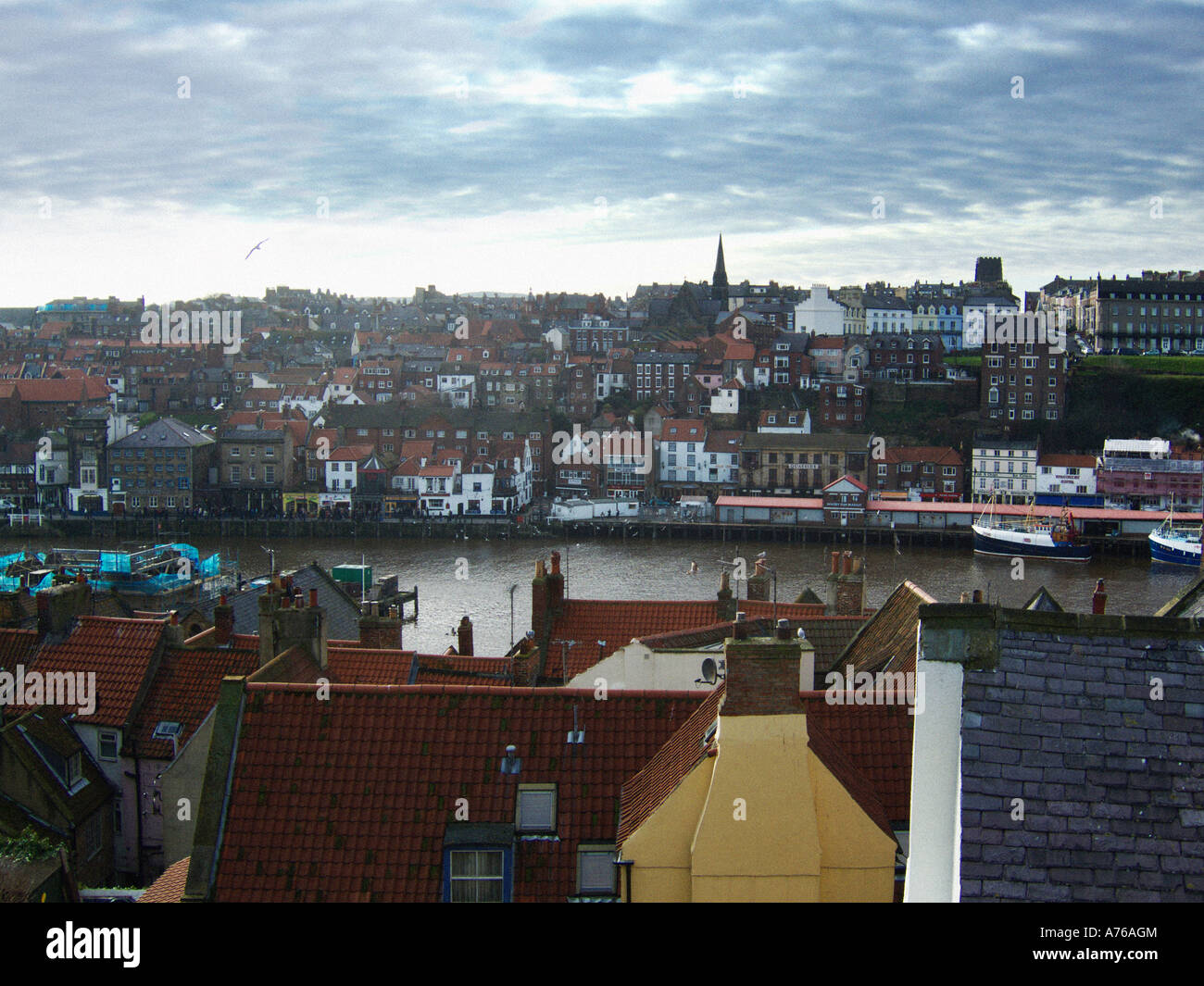 View over the Whitby's East cliff roof tops, towards the harbour, Pier ...