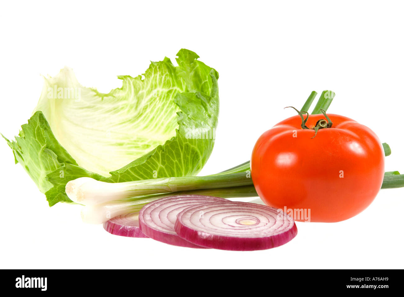 Selection of fresh salad vegetables, lettuce, spring onion, red onion ...