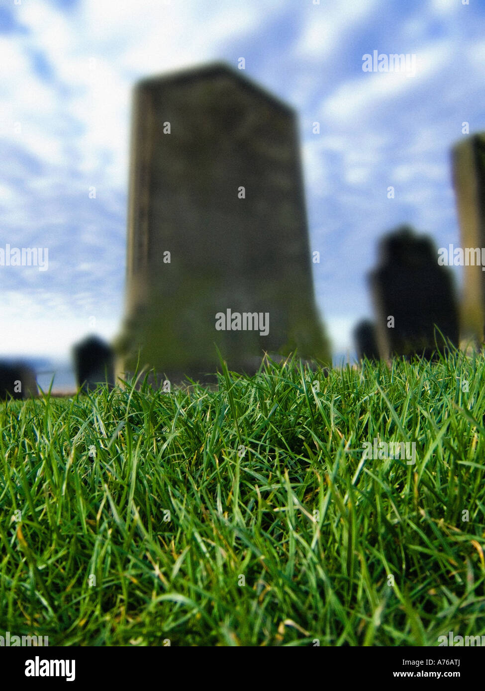 Blurred gravestones shot from a low angle in a churchyard with sharp ...
