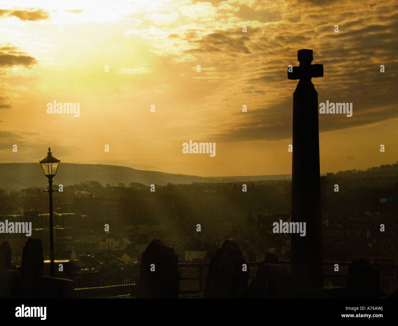 Silhouette of Caedmon's cross on the west side of the churchyard of St ...
