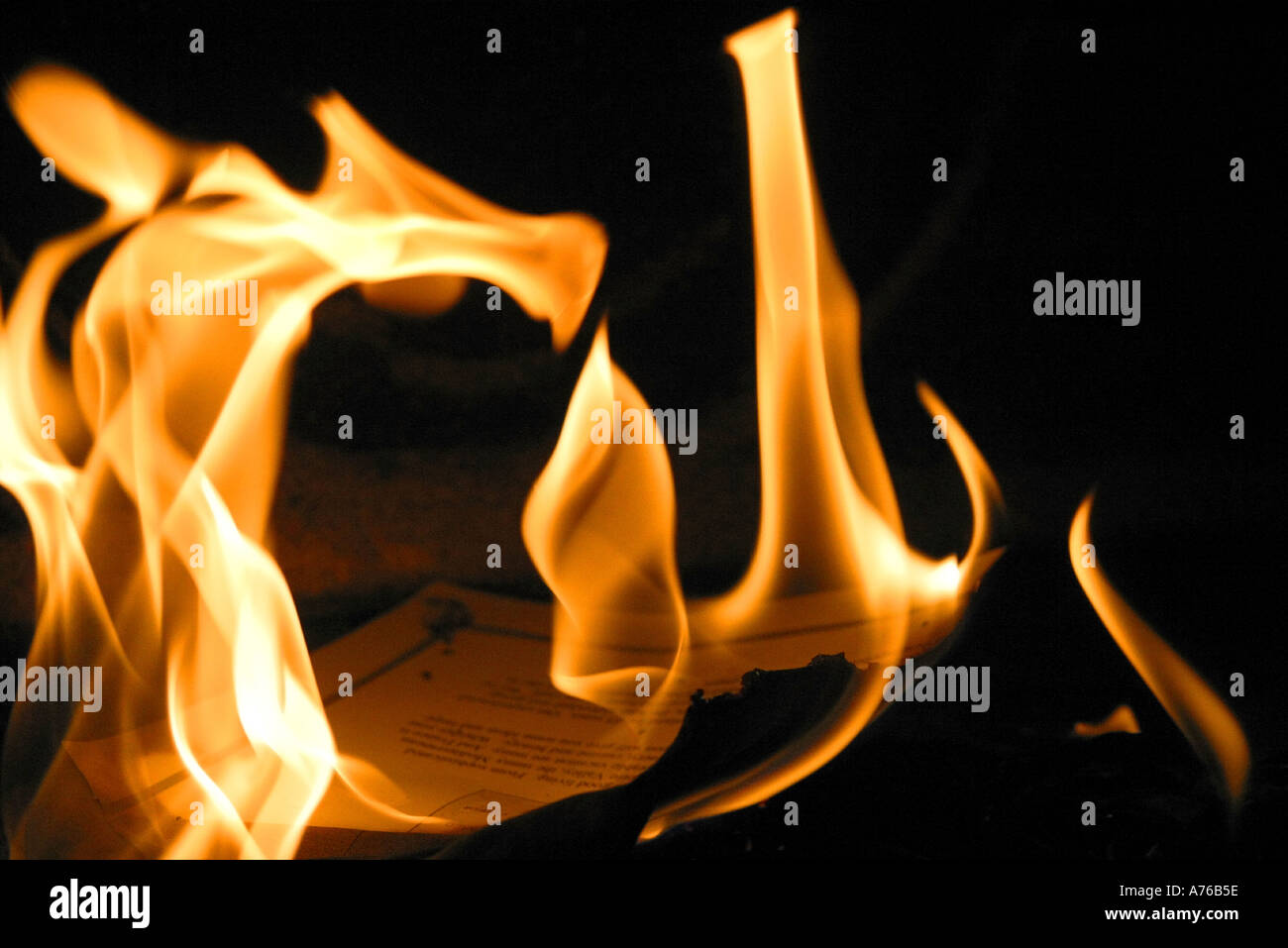 Closeup of fire and flames burning a piece of paper Stock Photo - Alamy