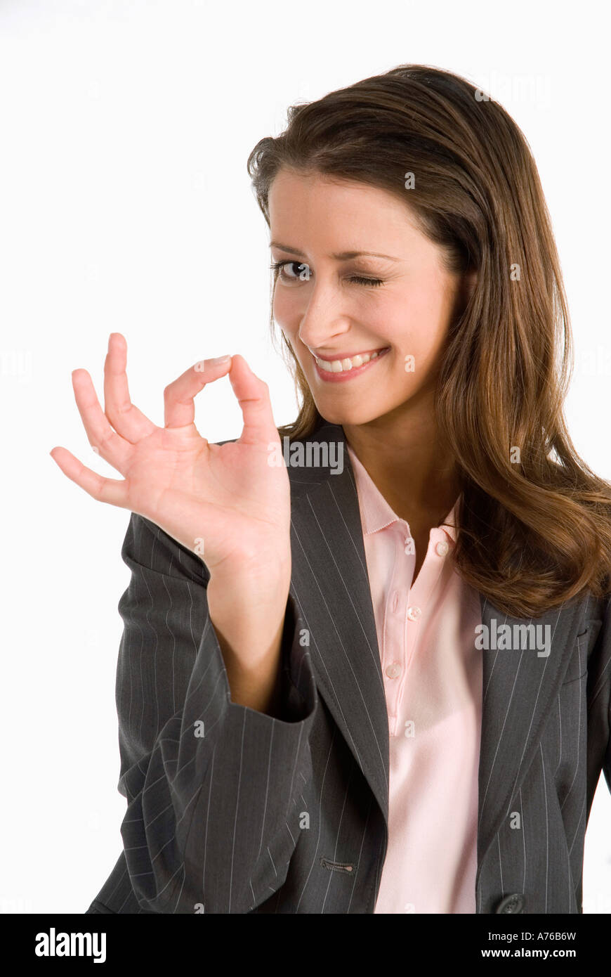 Businesswoman making ok sign, winking, portrait, close-up Stock Photo ...