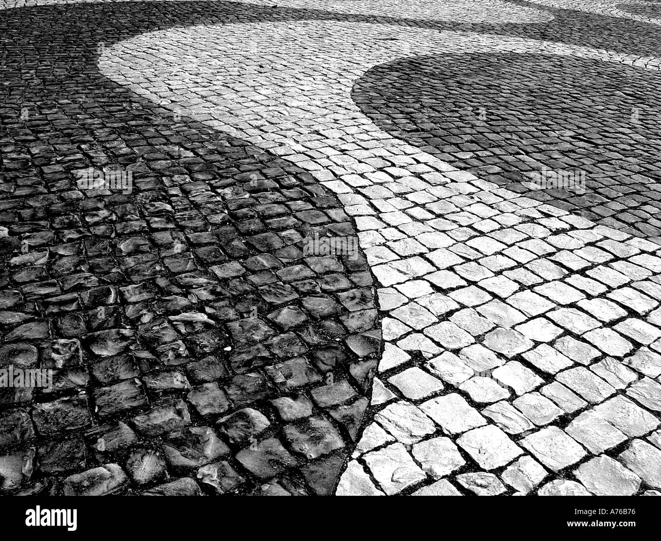 Pattern of the stone mosaic sidewalks and cobblestone streets in Lisbon ...