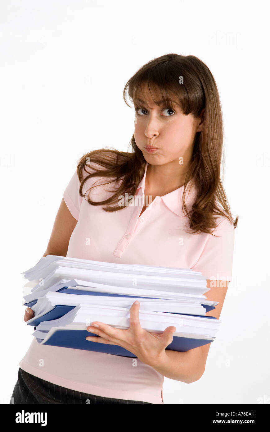 Young woman carrying files, looking up, close-up Stock Photo - Alamy