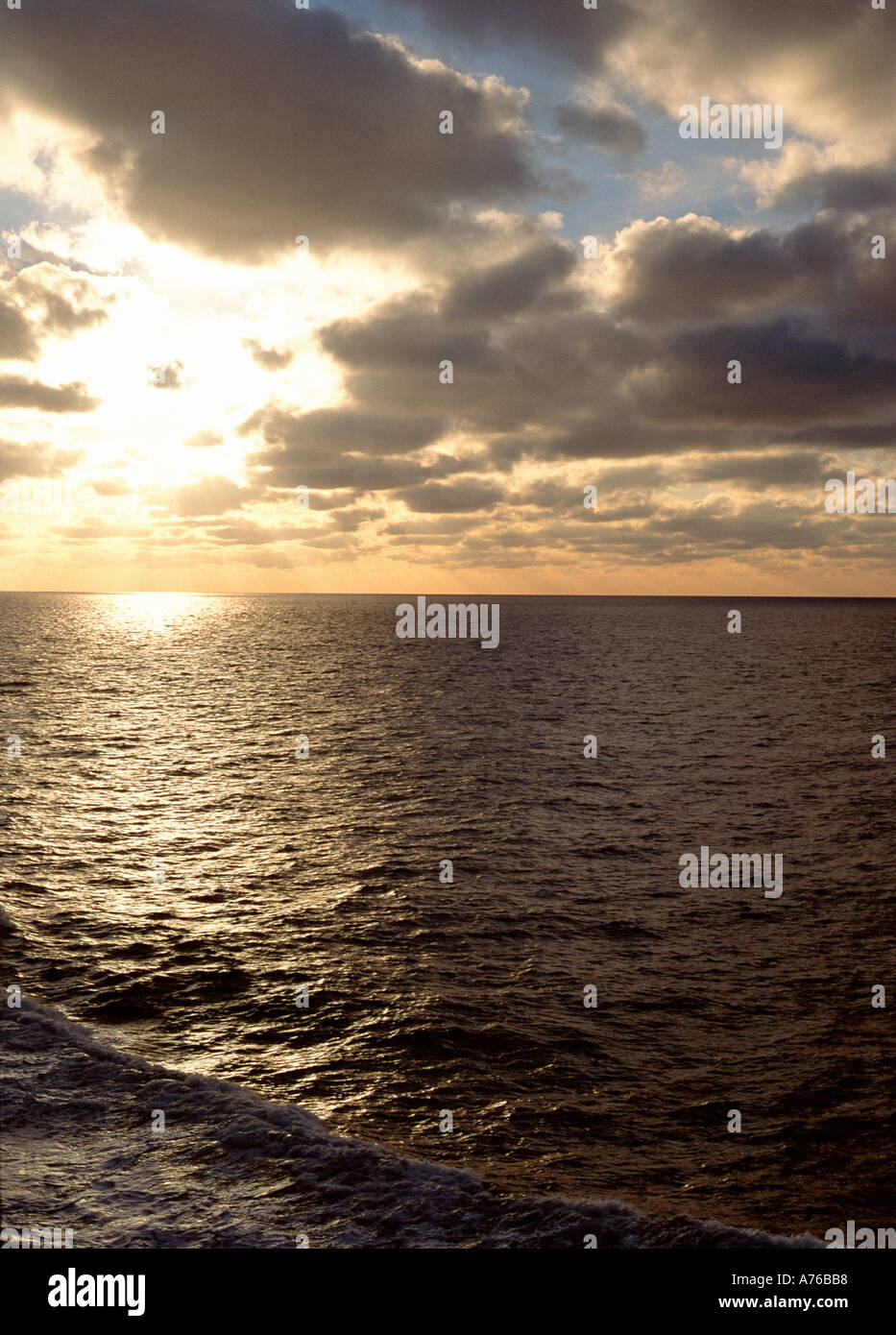 Sun Setting Over Sea Stock Photo - Alamy