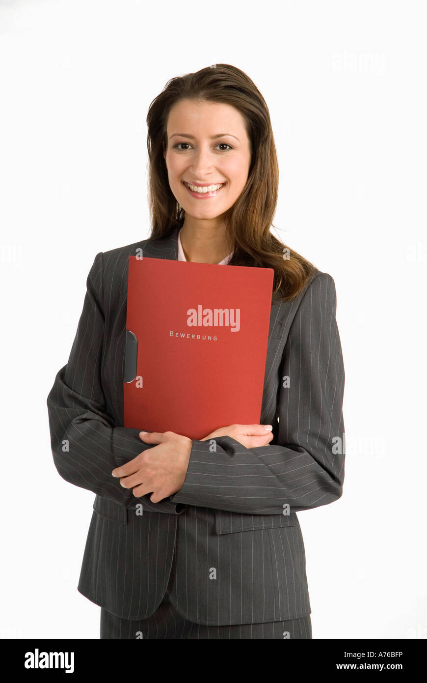 Businesswoman standing, holding file, smiling, portrait Stock Photo - Alamy