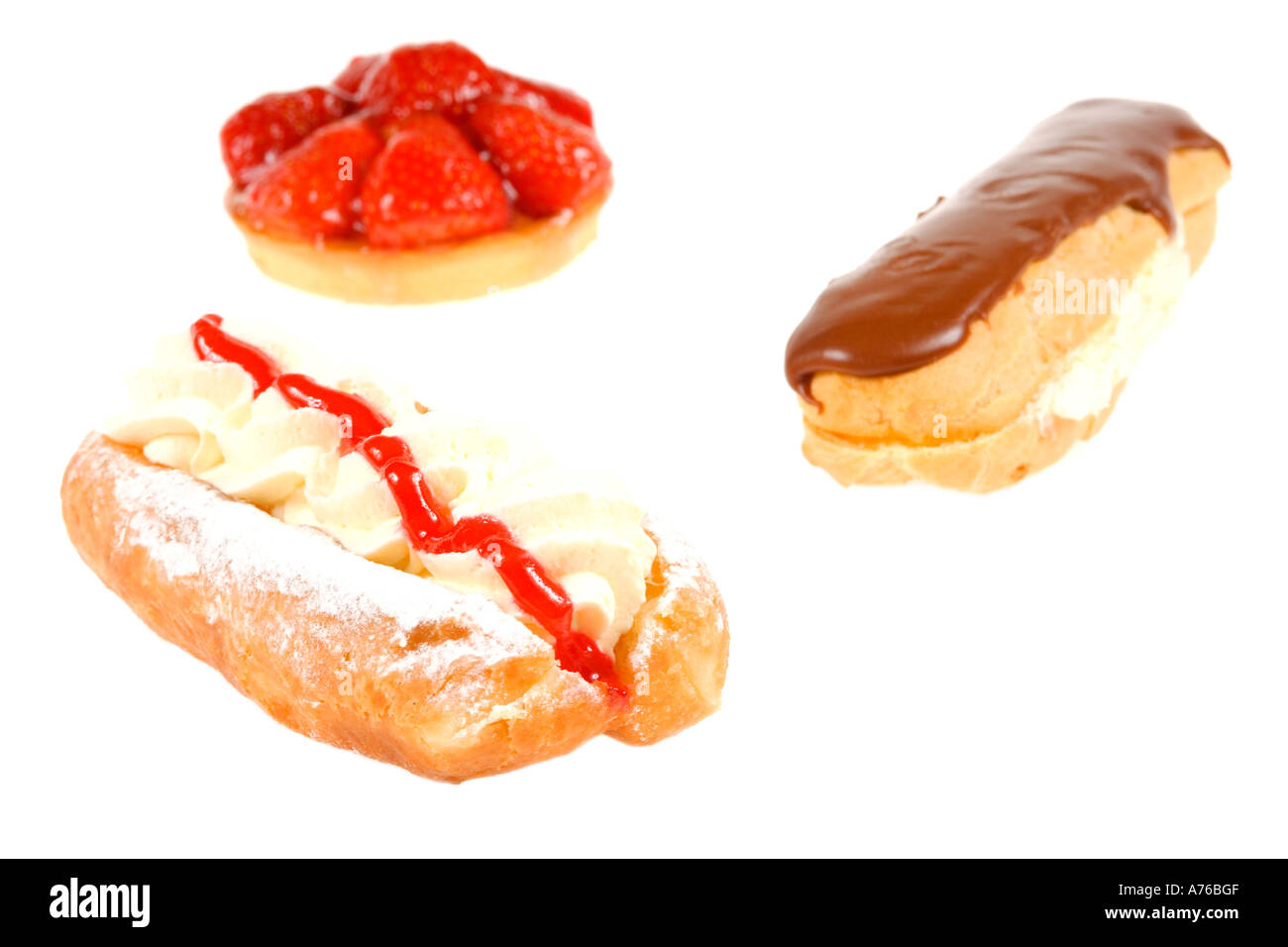 Display of assorted cream and fruit cakes on a pure white background ...
