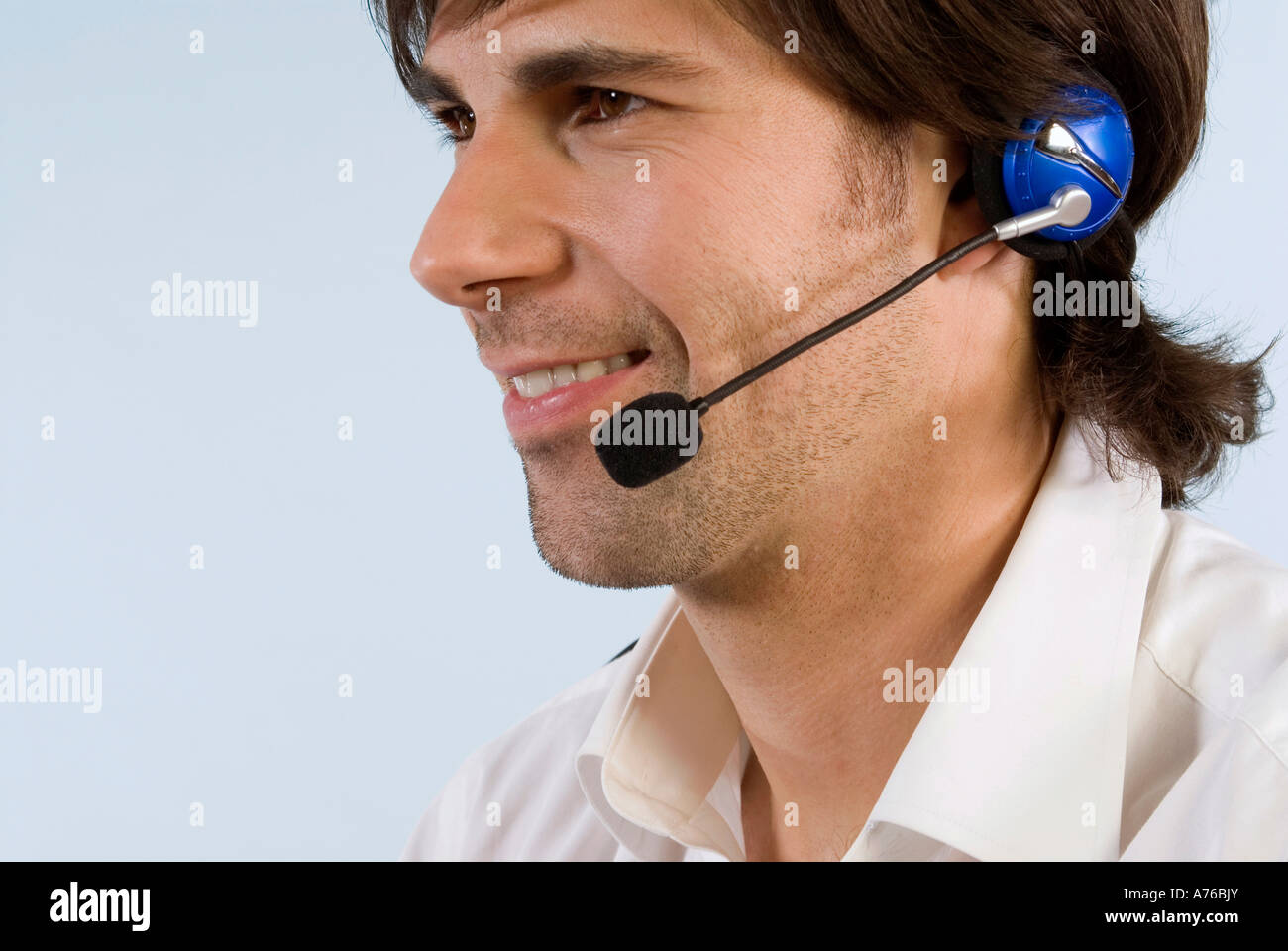 Businessman wearing headset, smiling, close-up, side view Stock Photo ...
